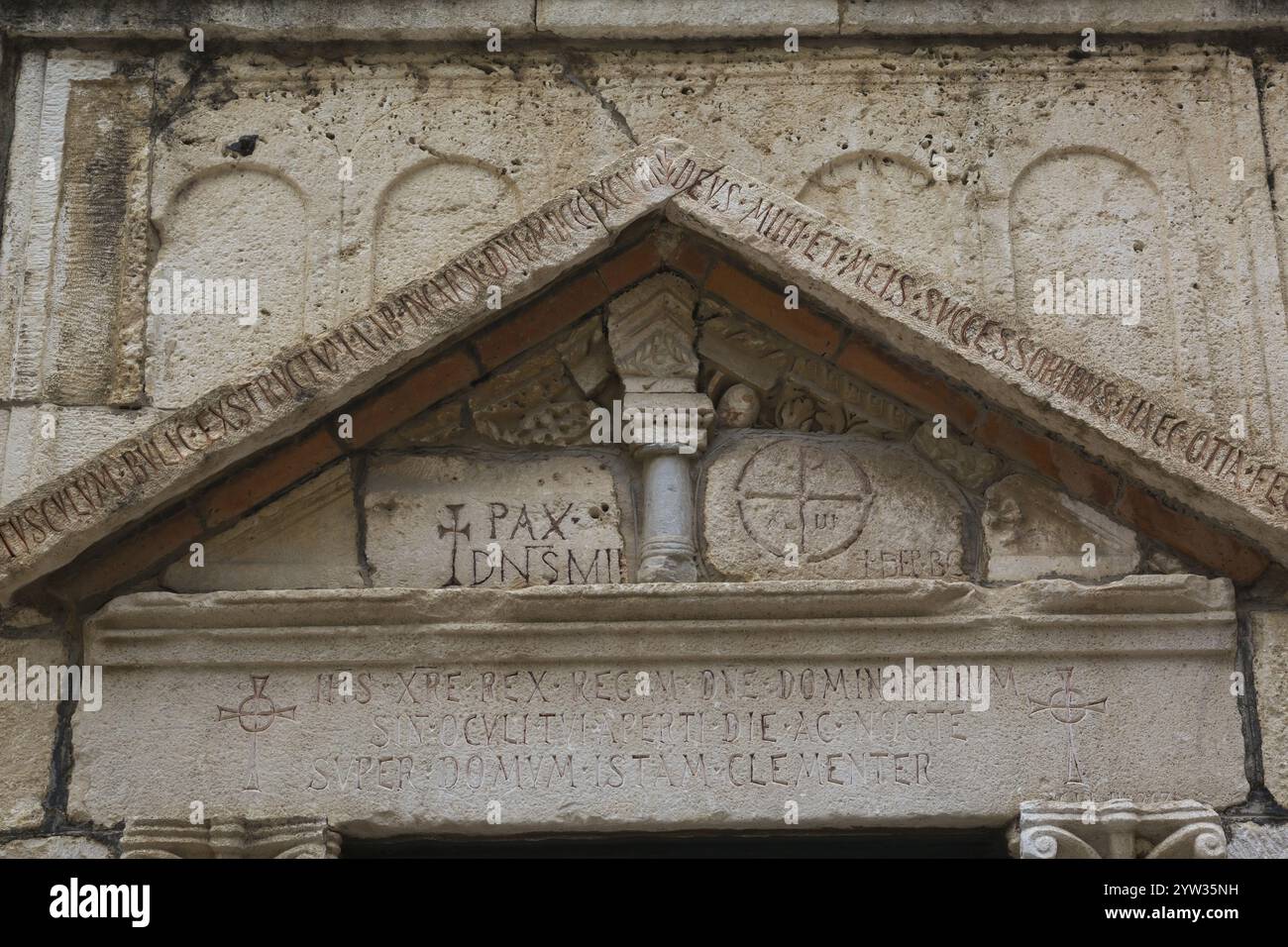 Close-up of carved letters and ancient symbols on old limestone ...
