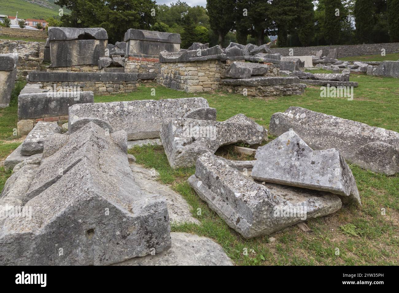 Close-up of old large and heavy broken pieces of cut and carved grey ...