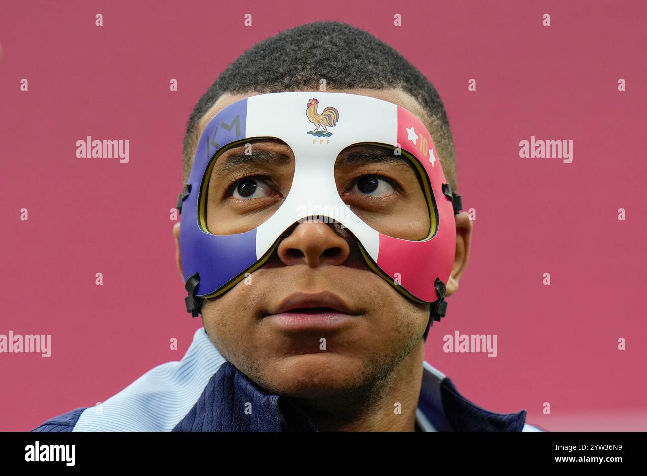 FILE - France's Kylian Mbappe looks up as he wears a face mask during a ...