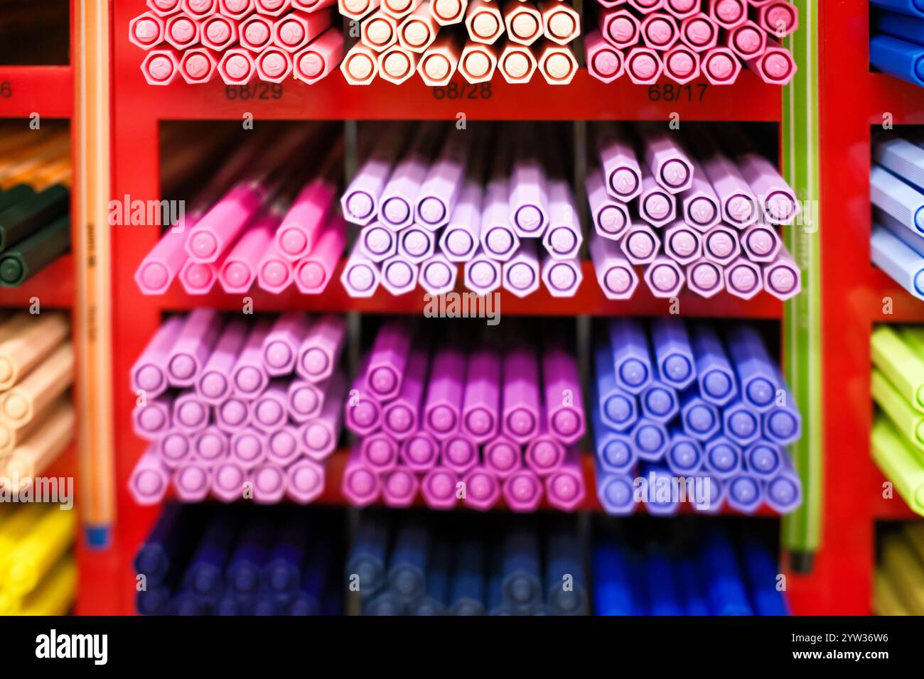 Colorful markers and pens arranged neatly on a store display rack with ...