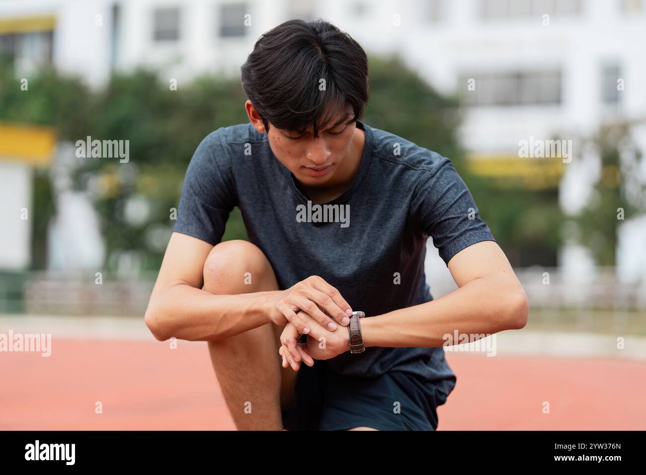 Athlete checking performance metrics track field sports urban ...