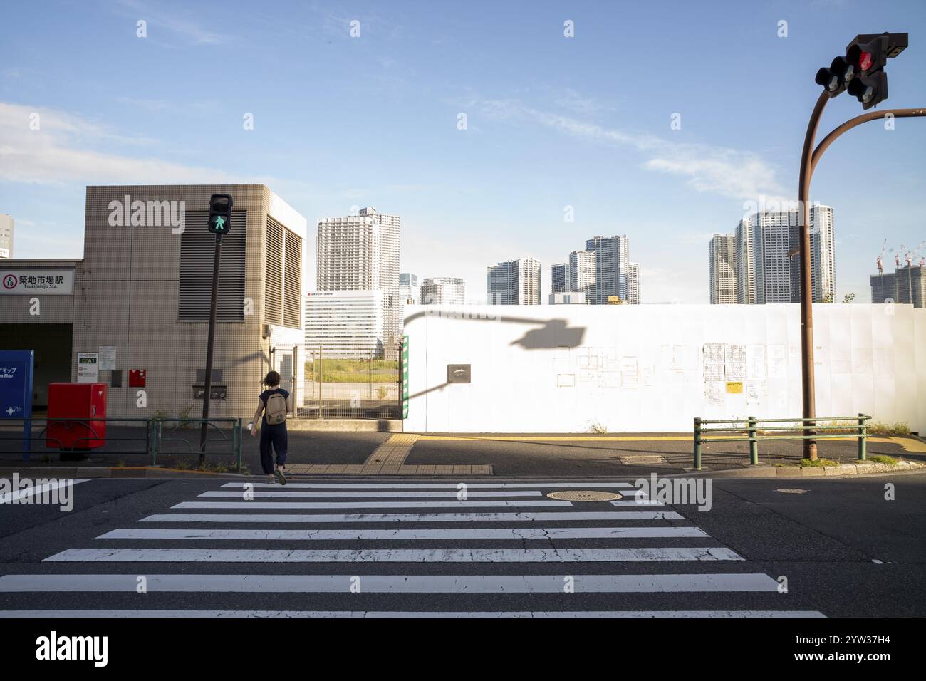 Skyline with skyscrapers under construction, red traffic light, shadow ...