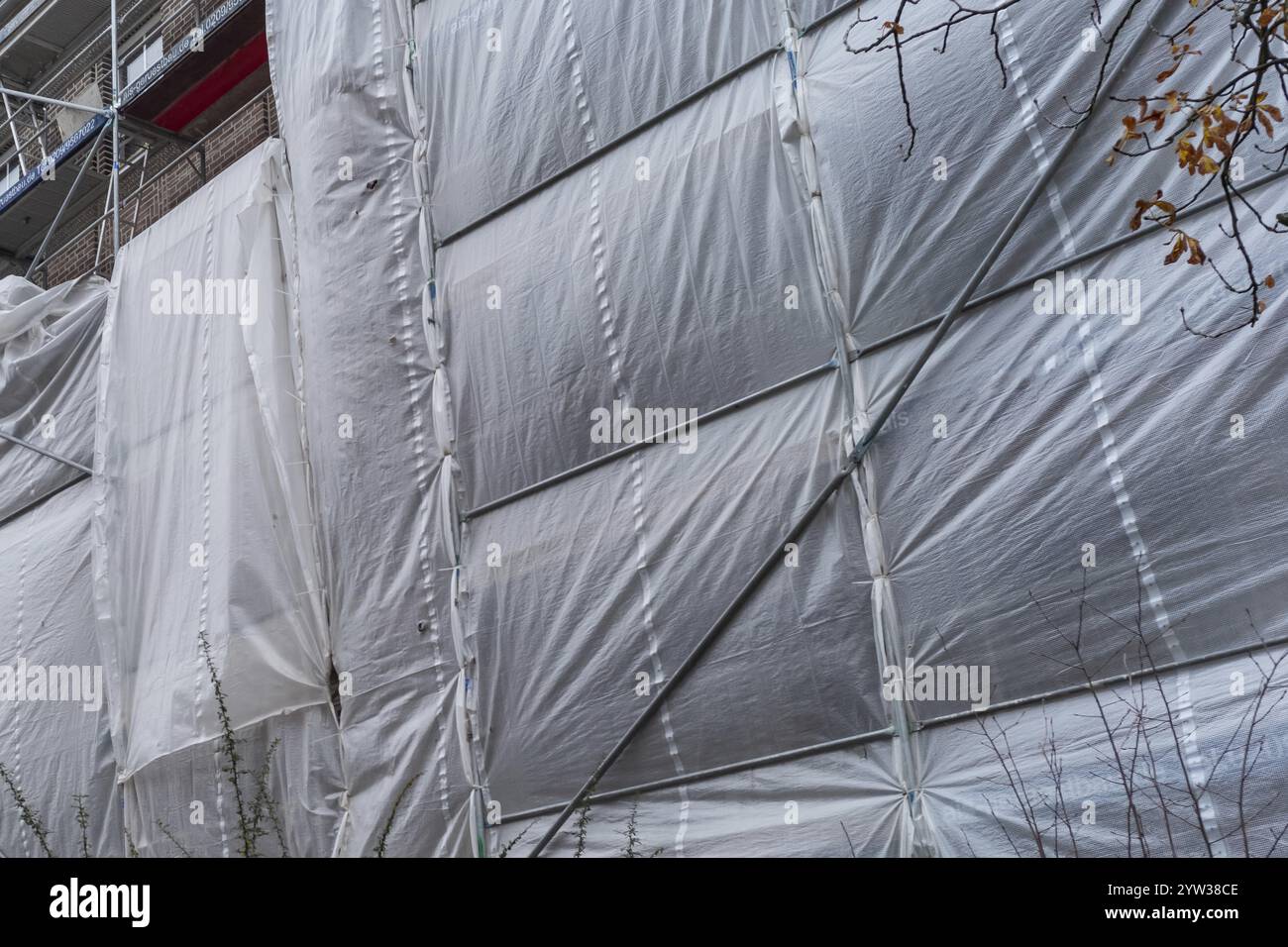 Building covered with a tarpaulin Stock Photo - Alamy