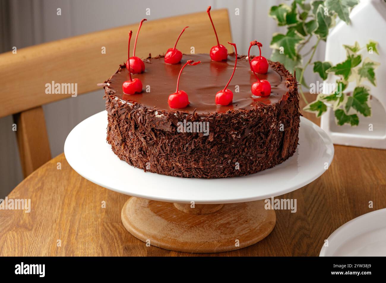 a whole chocolate cake decorated with cherries Stock Photo - Alamy