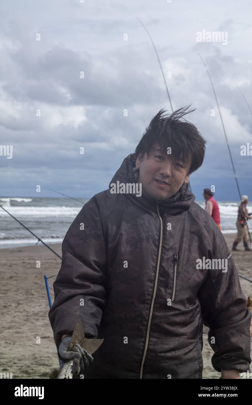 Portrait of fisherman with fish in hand, Shari port Breakwater ...