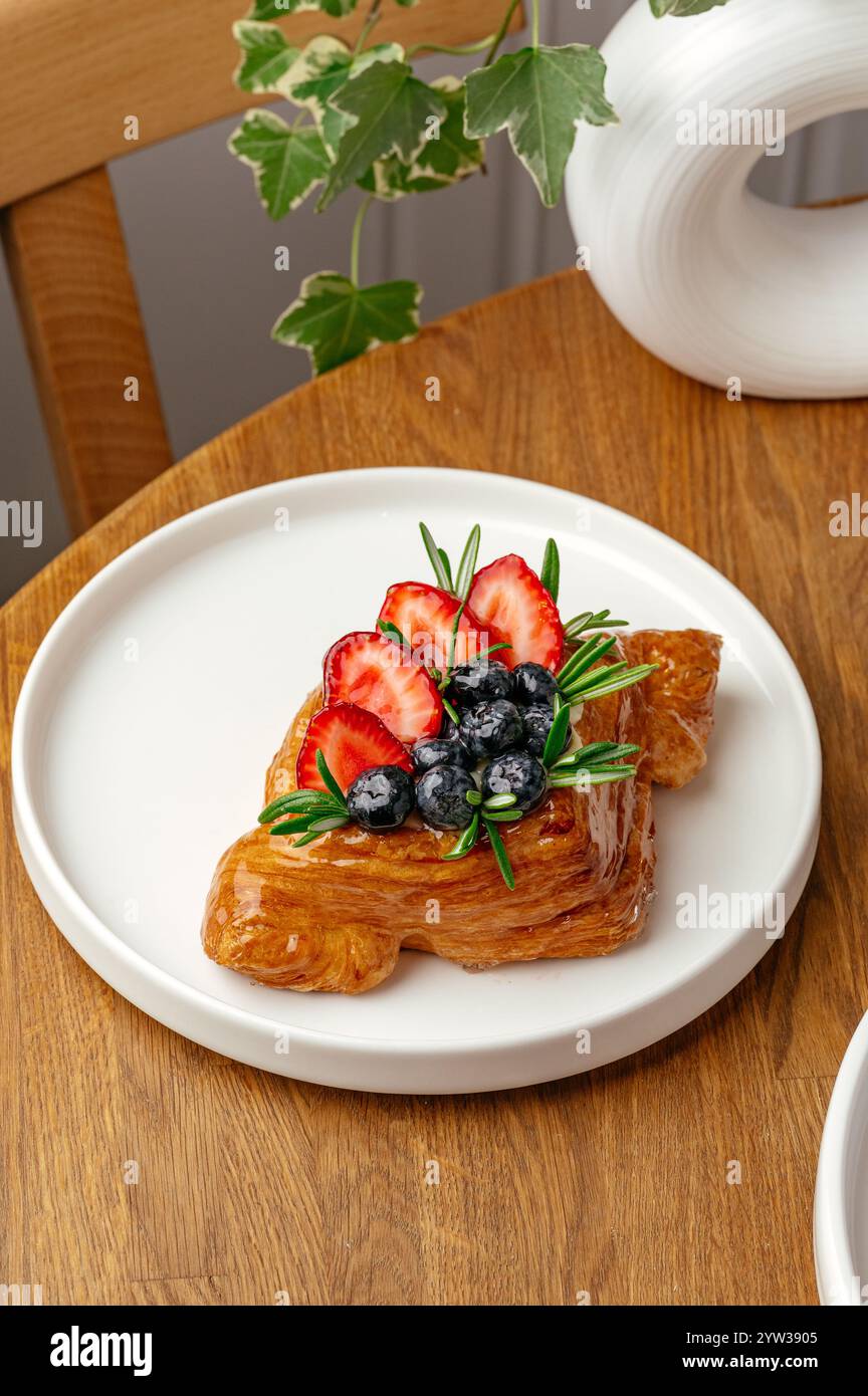 puff pastry dessert with cream and berries in the shape of a bow Stock ...
