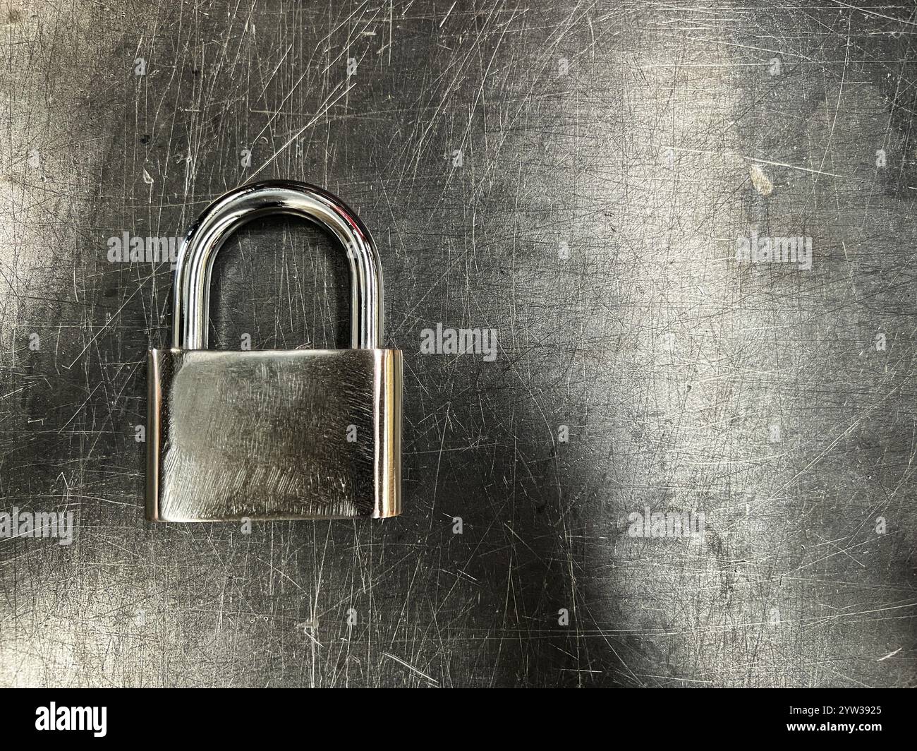 Metallic padlock on metal texture background Stock Photo - Alamy