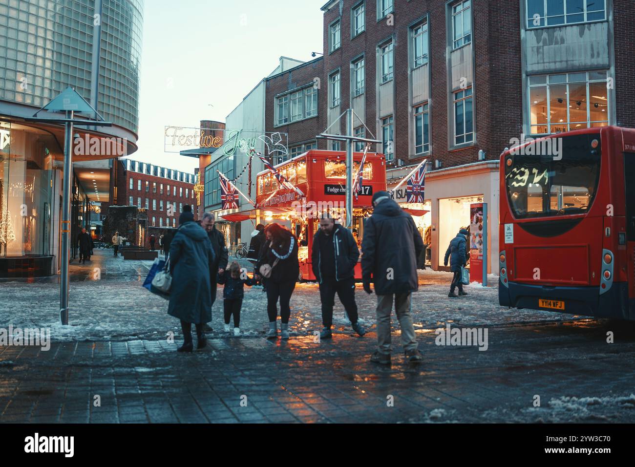 People crossing road in front of Christmas decorations in Exeter Stock ...