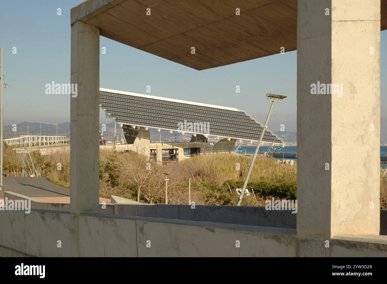 Concrete architectural structure framing a view of a solar panel array ...