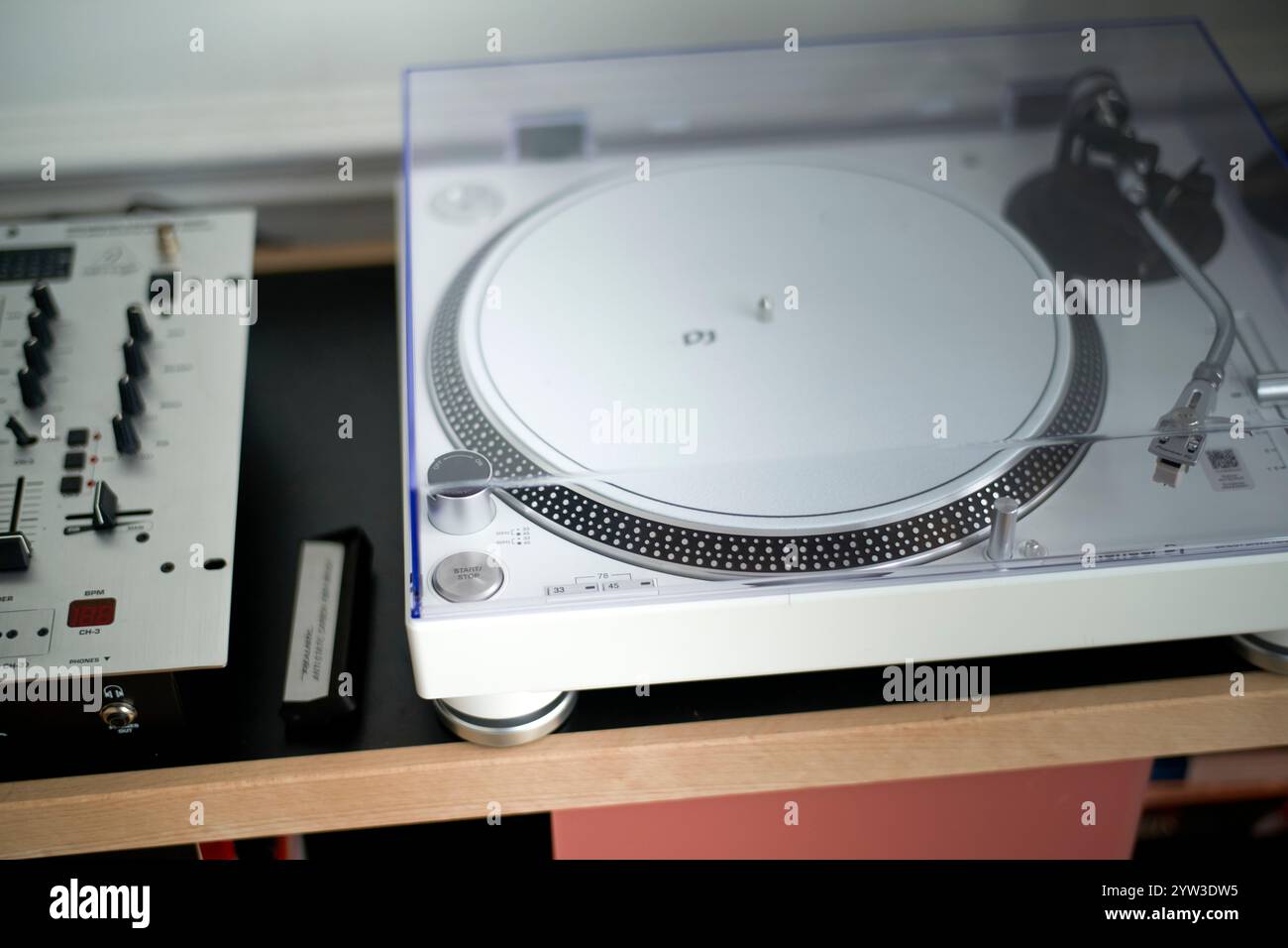 Close-up of a modern turntable with DJ equipment on a desk ...