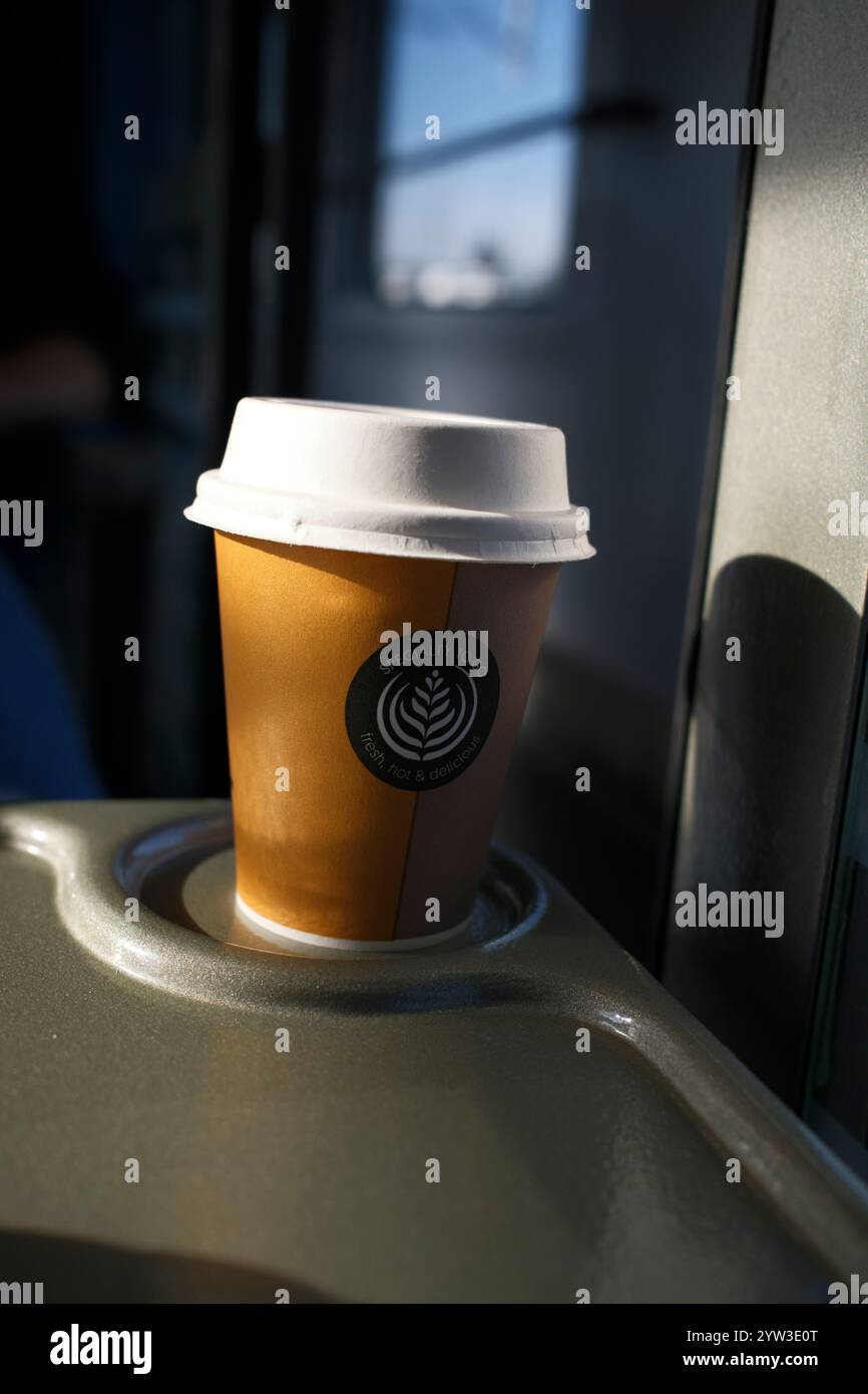 Morning coffee cup in a train cup holder bathed in sunlight Stock Photo - Alamy