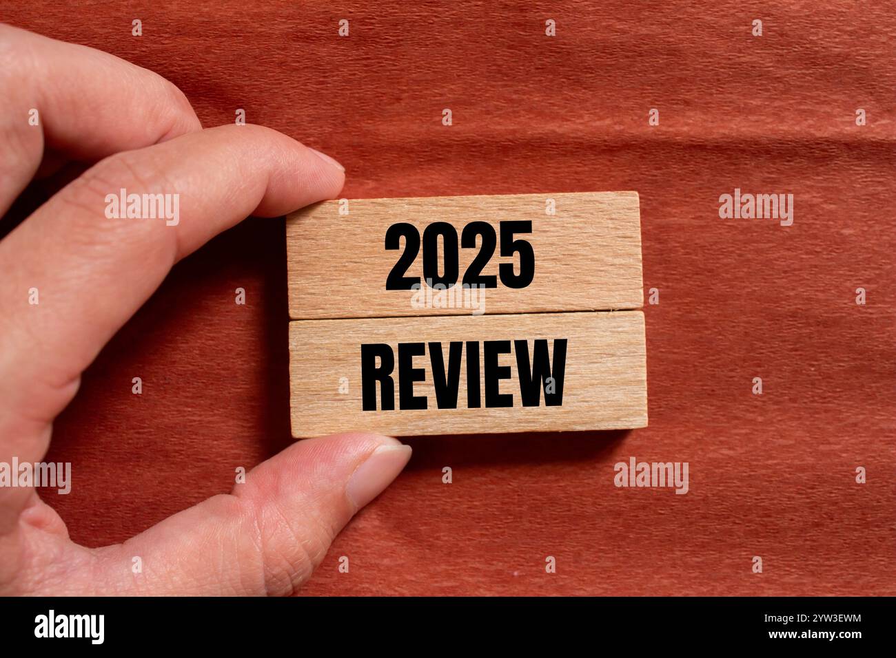 2025 review message written on wooden blocks with brown background. Conceptual 2025 review ...