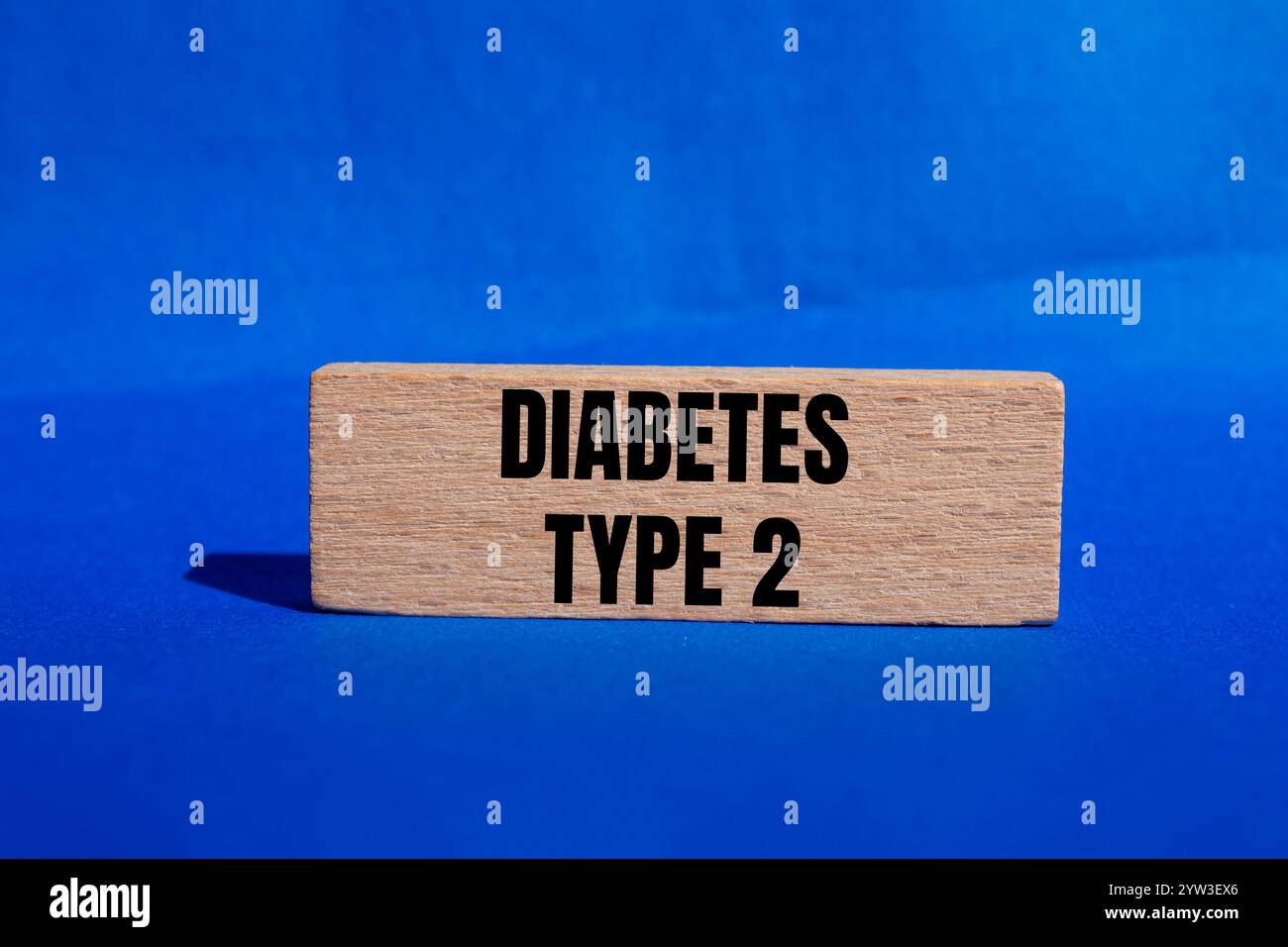 Diabetes type 2 message written on wooden block with blue background ...