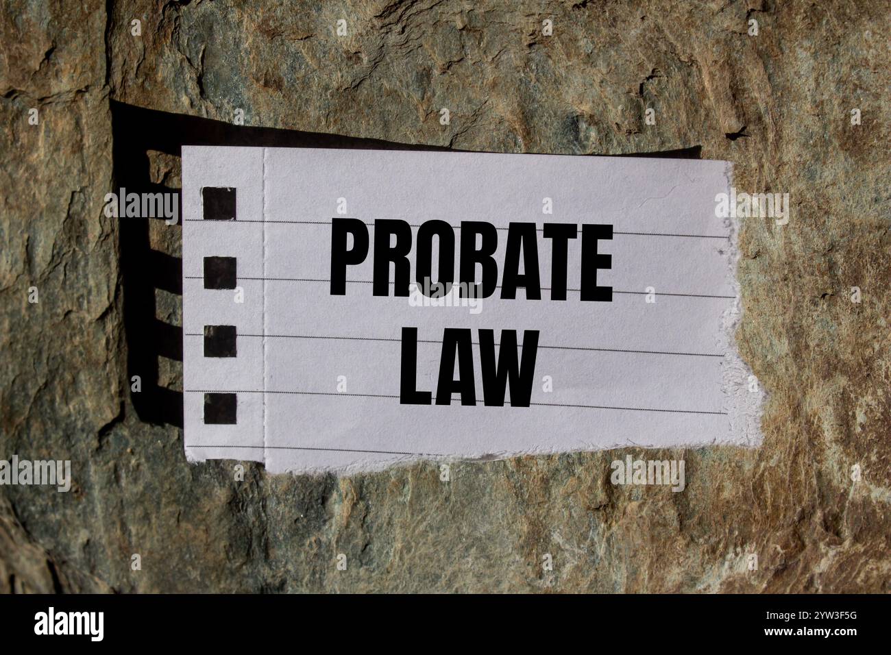 Probate law message written on ripped torn paper piece with stone ...