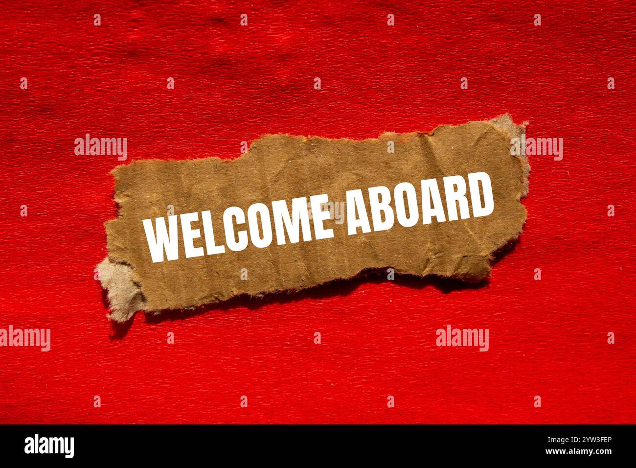 Welcome aboard message written on ripped torn cardbaord paper piece ...
