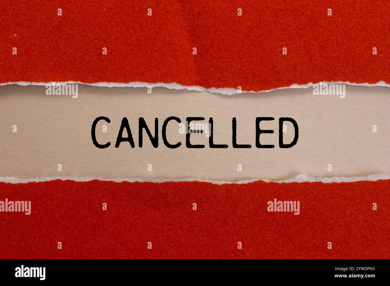 Cancelled message written on ripped torn red paper with beige background. Conceptual cancelled ...