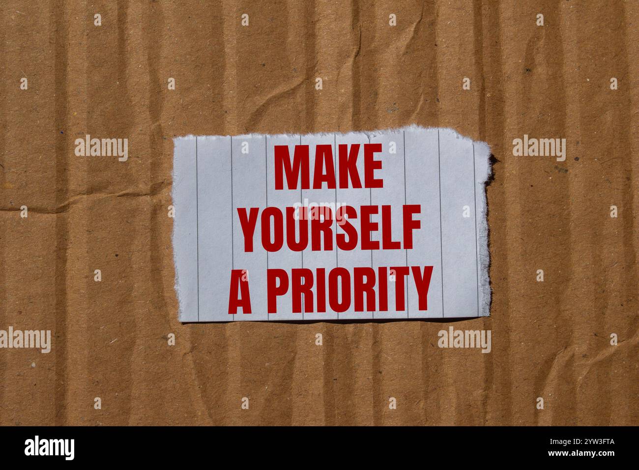 Make yourself a priority message written on ripped torn paper piece ...
