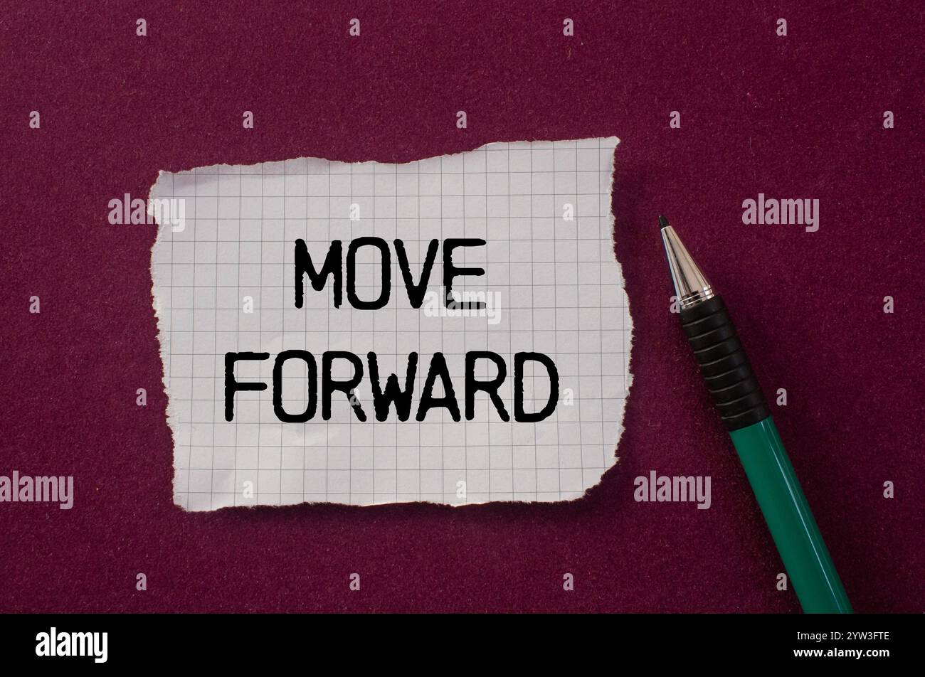 Move forward message written on ripped torn paper piece with purple background. Conceptual move ...