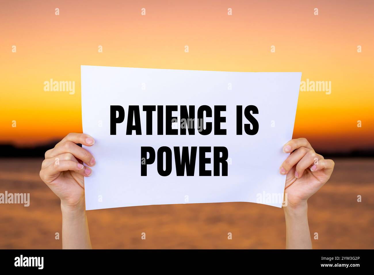 Patience is power message written on white paper with blurry lake background. Conceptual ...