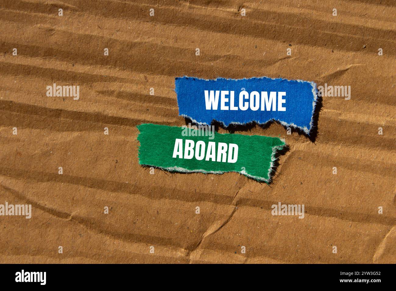 Welcome aboard message written on ripped torn paper pieces with ...