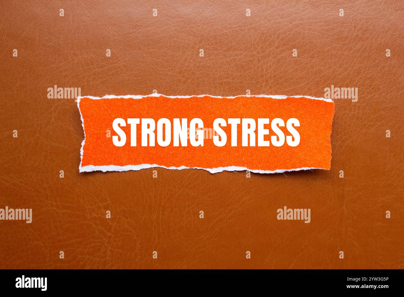 Strong stress message written on ripped orange torn paper piece with ...