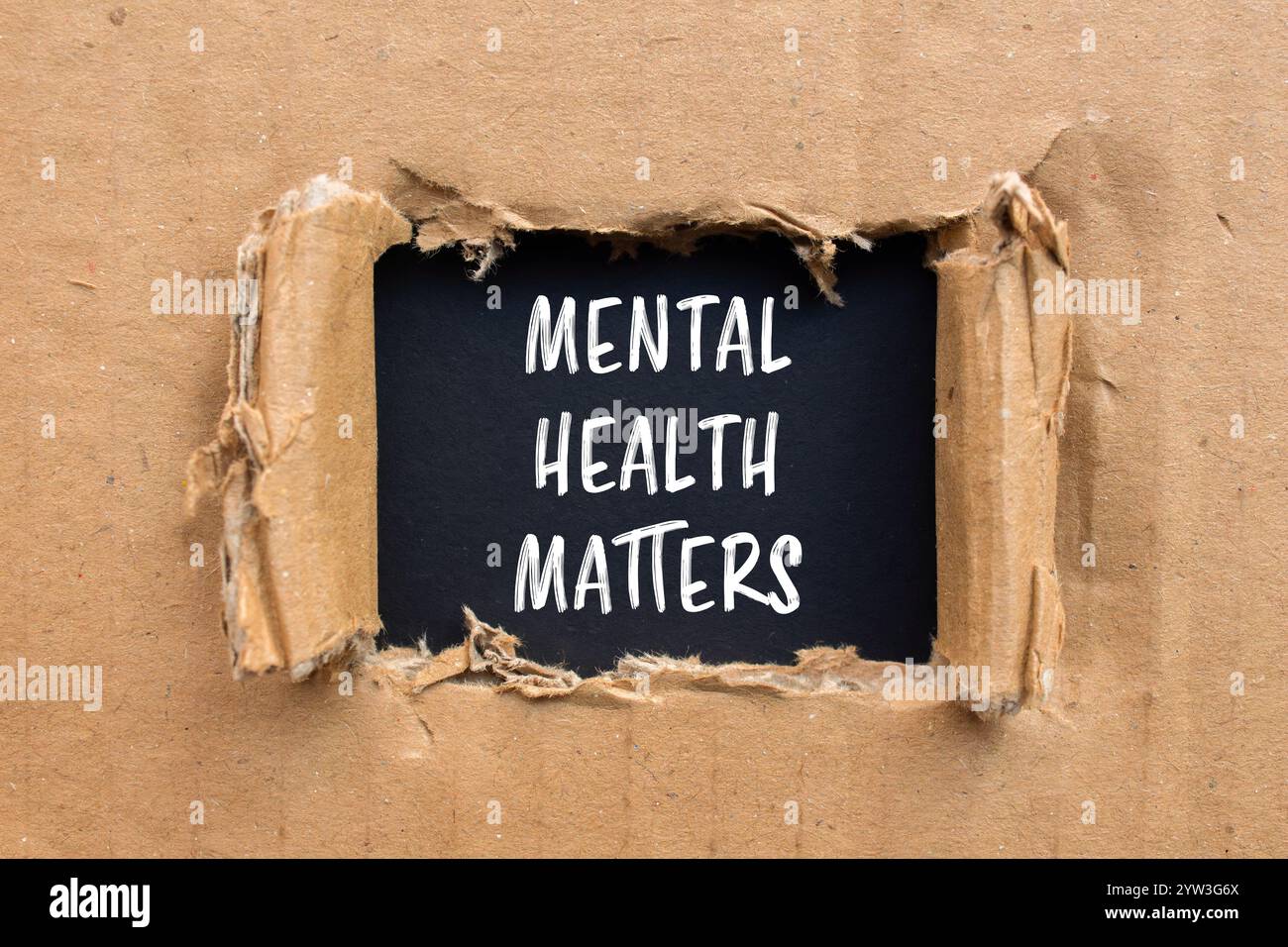 Mental health matters message written on ripped torn cardboard paper with black background ...