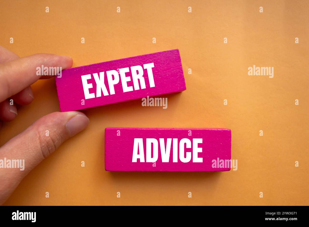 Expert advice message written on pink wooden blocks with orange ...