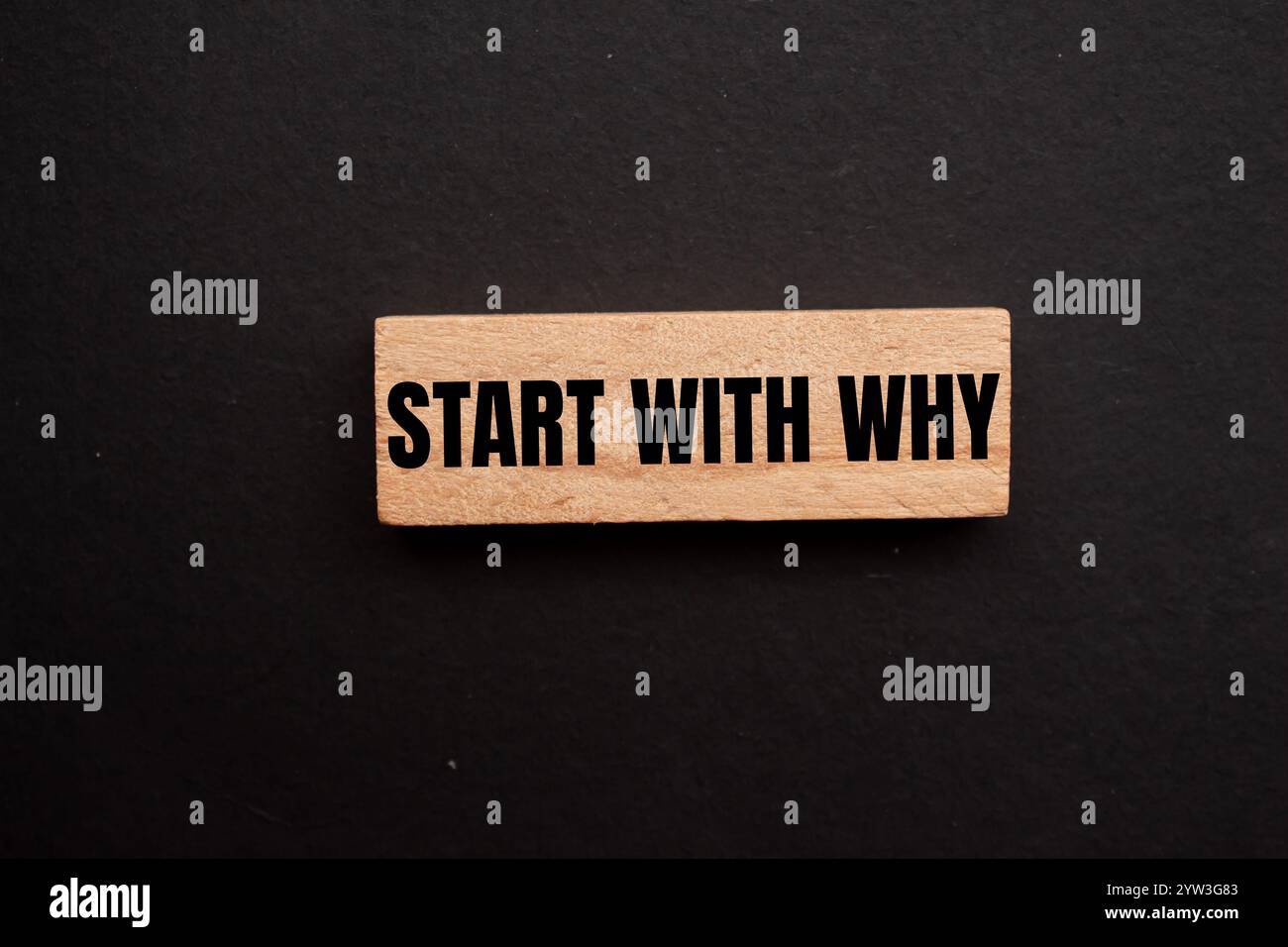 Start with why message written on wooden block with black background ...