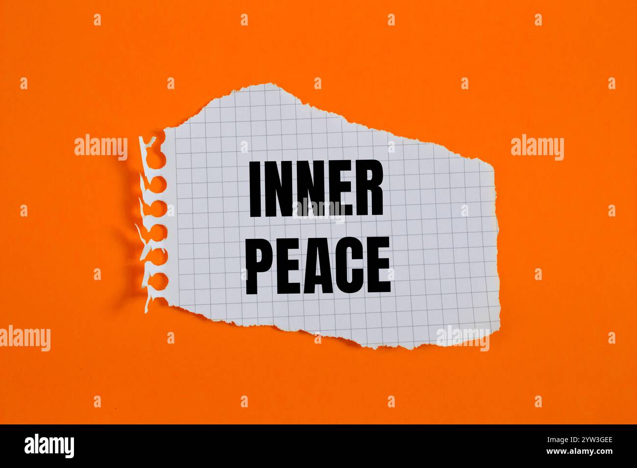 Inner peace message written on ripped torn checkered graph paper piece ...