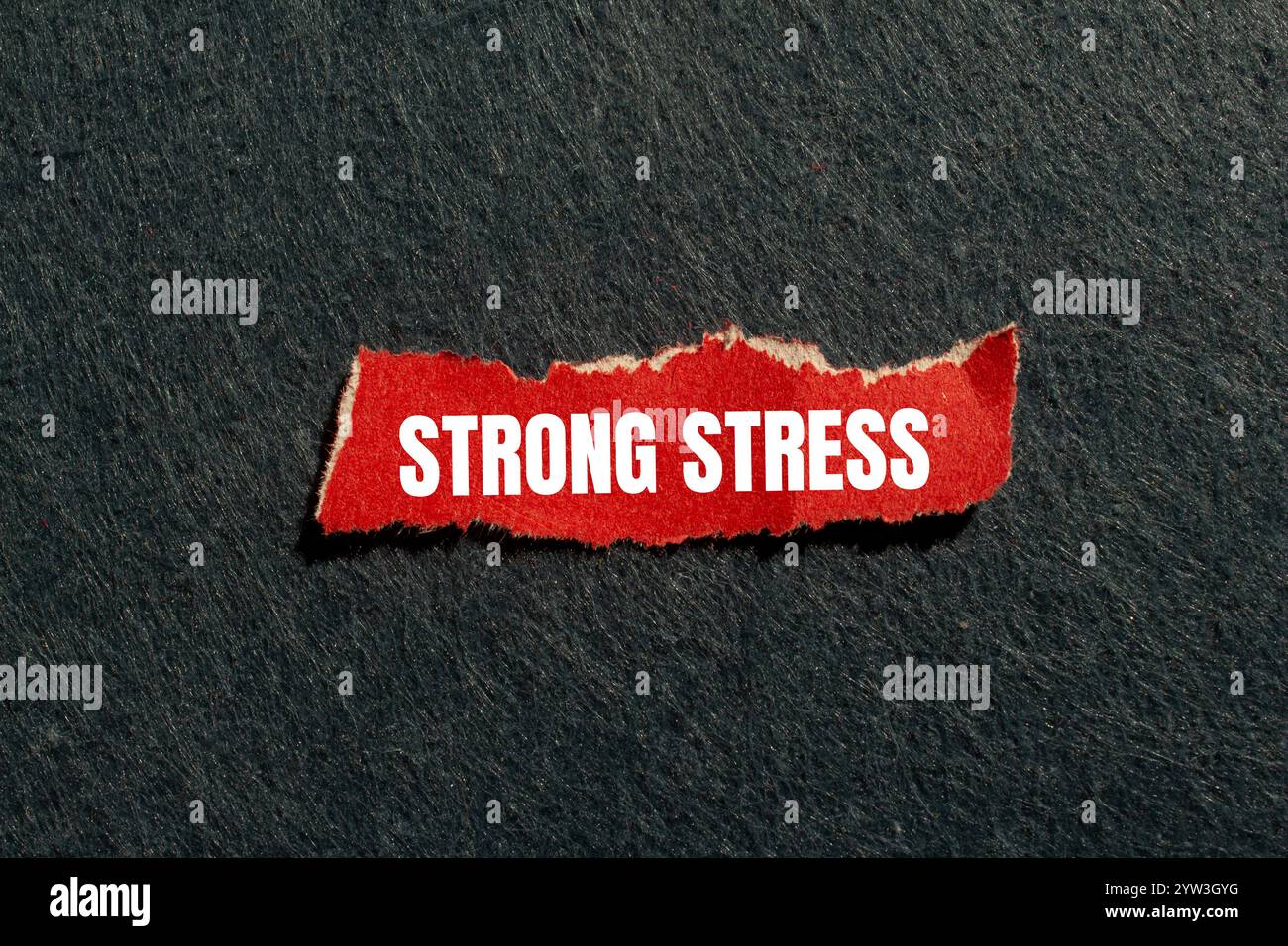 Strong stress message written on ripped torn red paper piece with gray ...