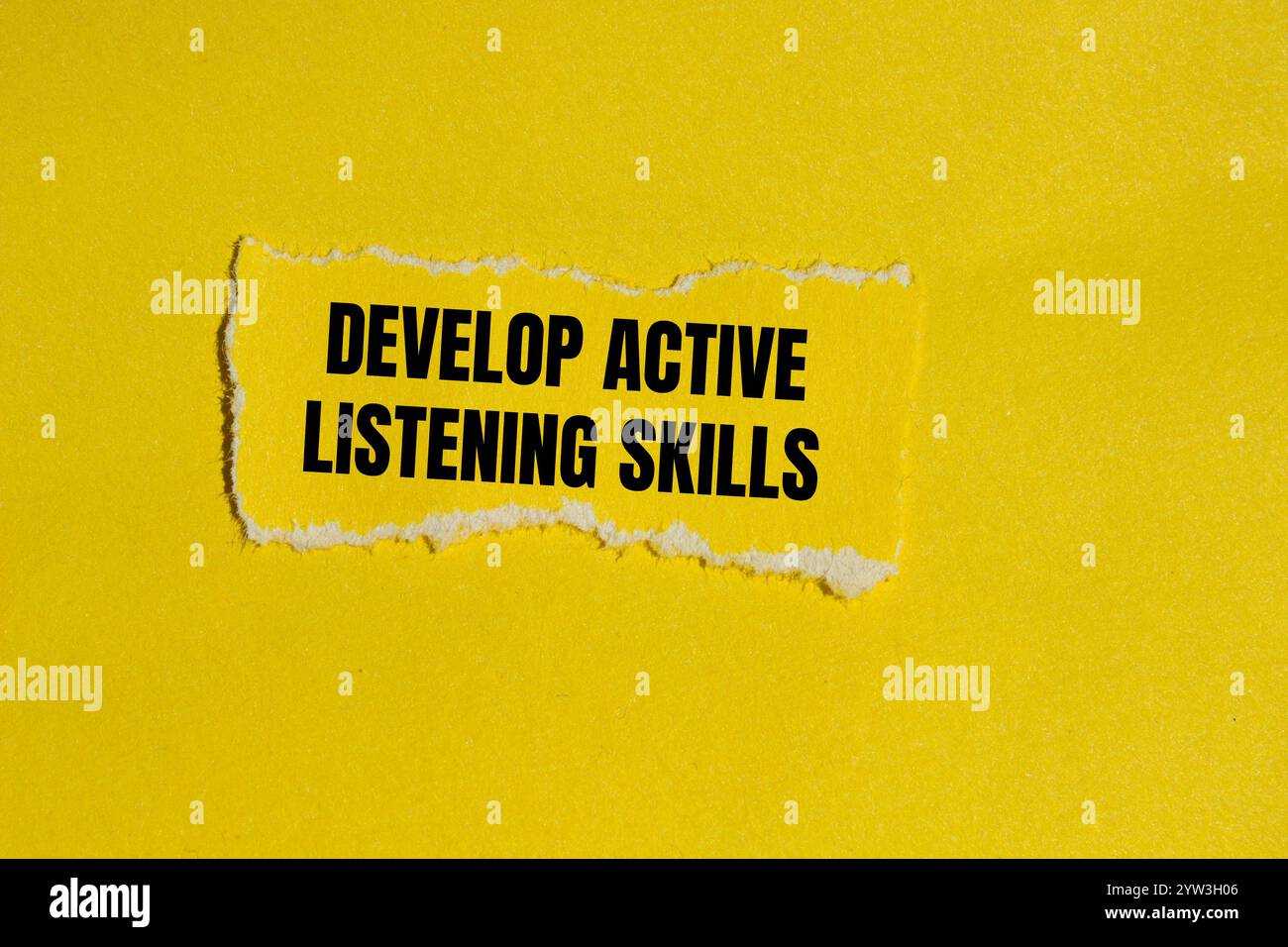 Develop active listening skills message written on ripped yellow torn ...