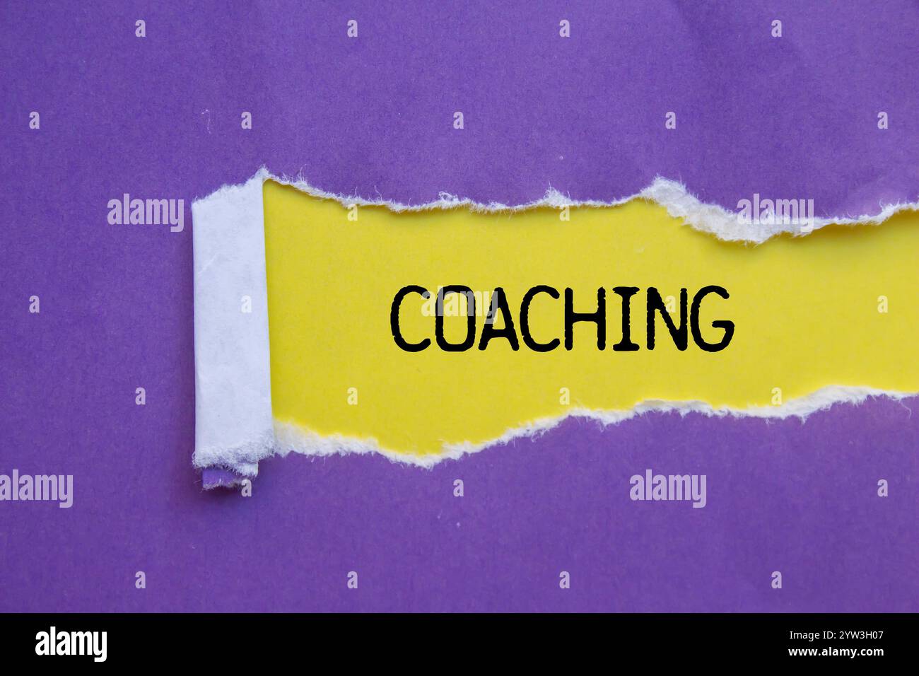 Coaching message written on ripped torn purple paper with yellow background. Conceptual coaching ...