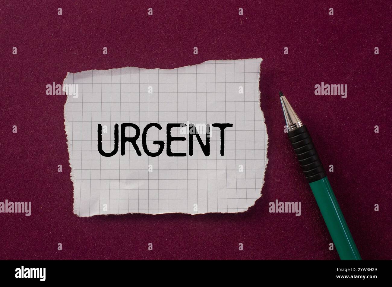 Urgent message written on ripped torn paper piece with purple ...