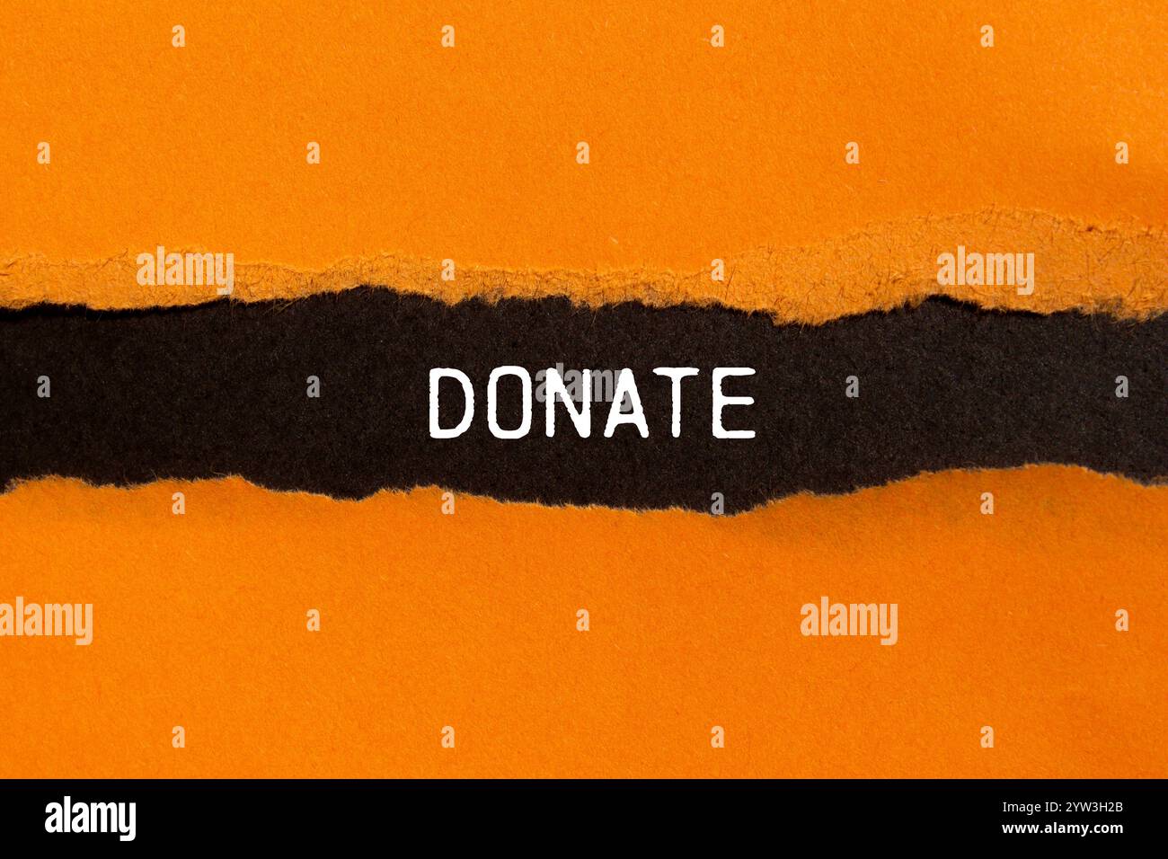 Donate message written on ripped torn orange paper with black ...