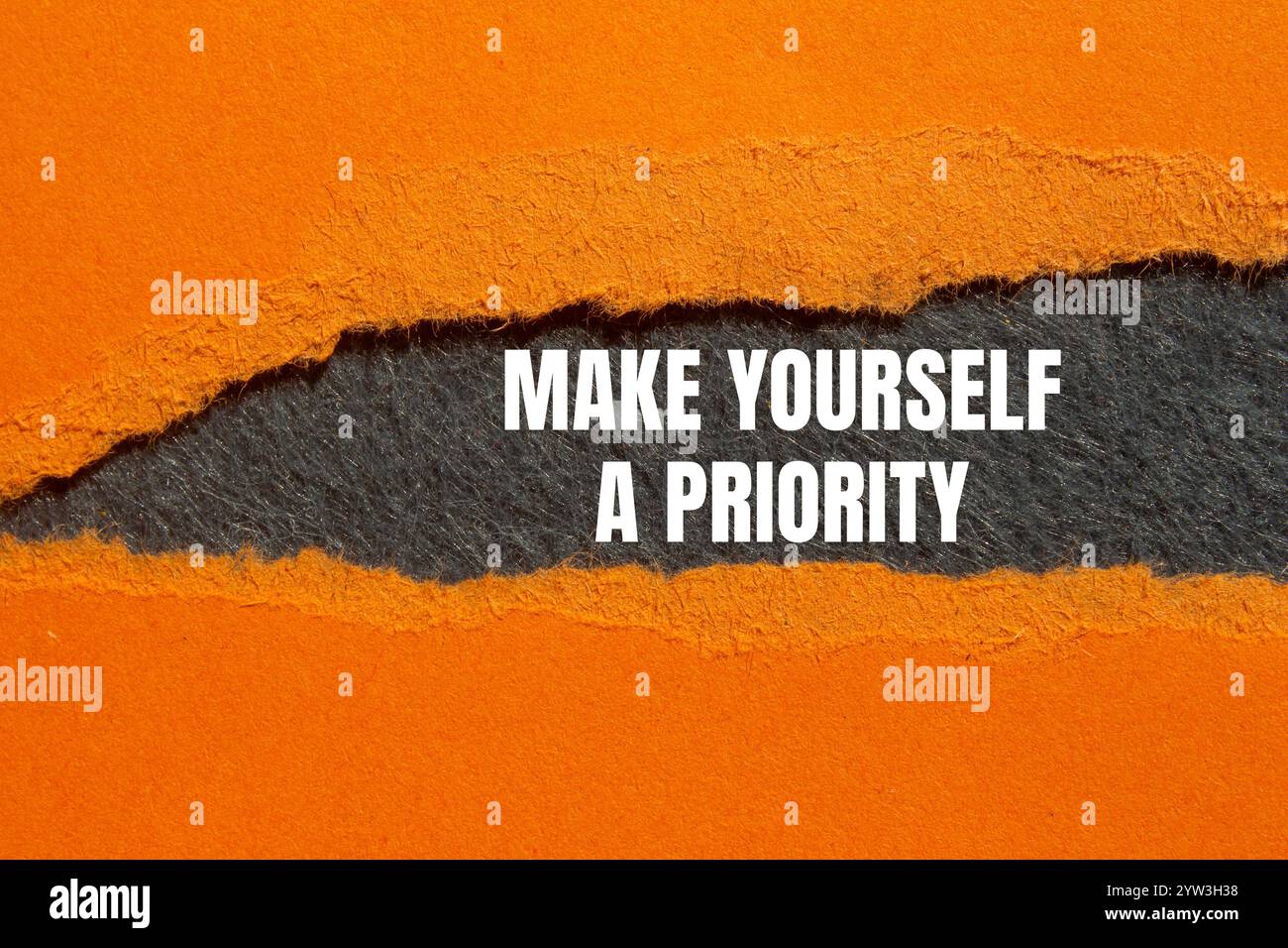 Make yourself a priority message written on ripped torn orange paper ...