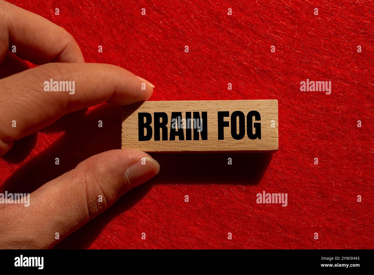 Brain fog message written on wooden block with red background ...