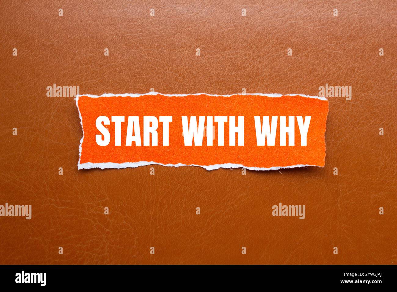 Start with why message written on ripped orange torn paper piece with brown background ...