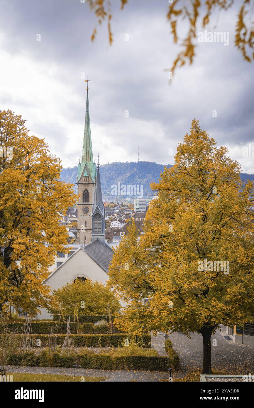 Autumnal city view with church tower and colourful trees, Zurich ...