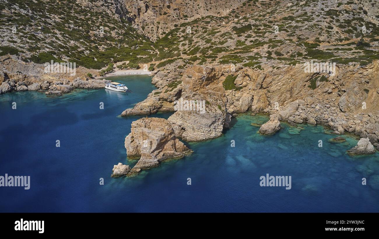 Palatia Beach, Palatia, Clear blue water and rocks in a quiet bay with ...