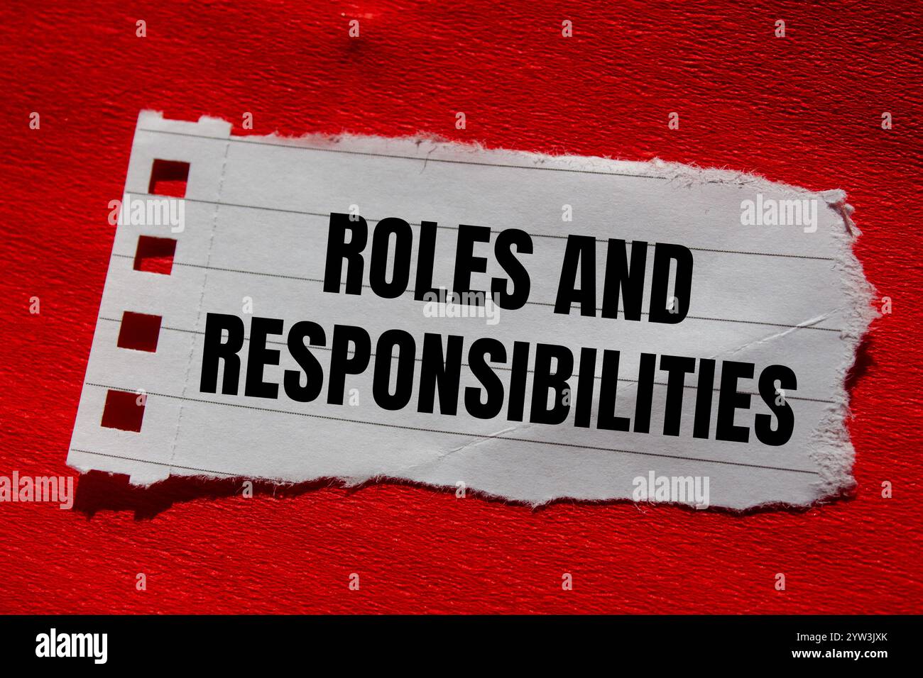Roles and responsibilities message written on ripped torn paper piece ...