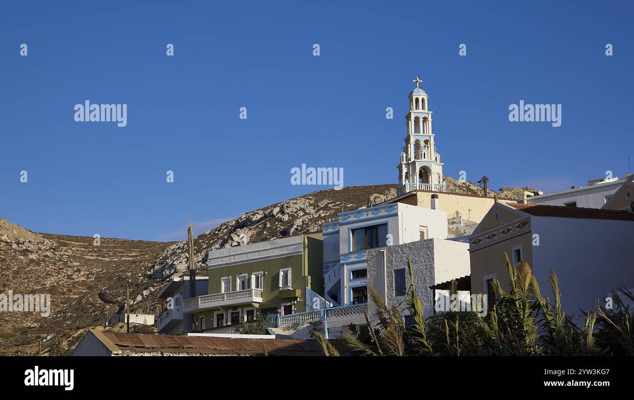Church tower towers over the village and stands under a clear sky ...