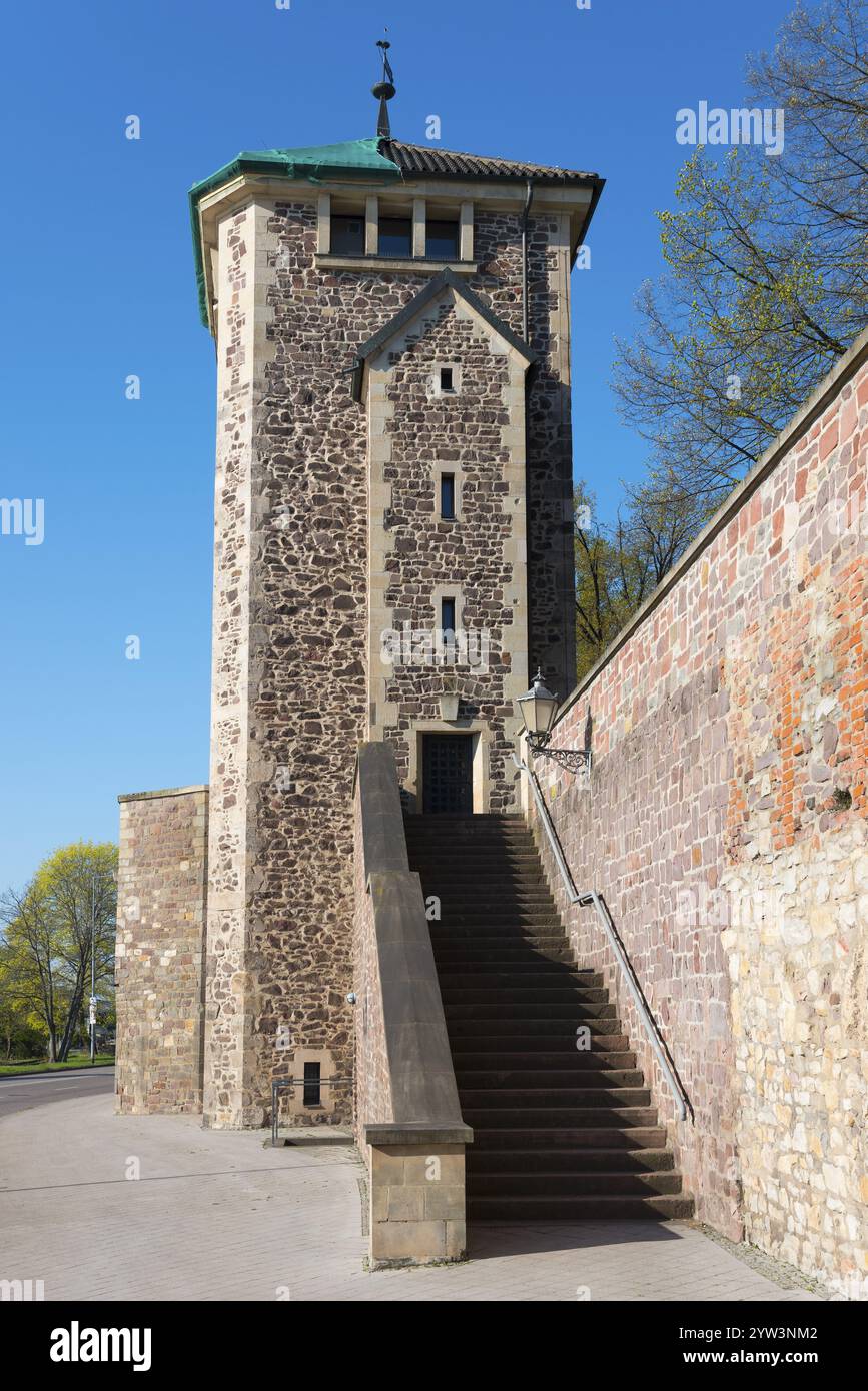Old stone defence tower with stairs and wall, blue sky and trees in the ...