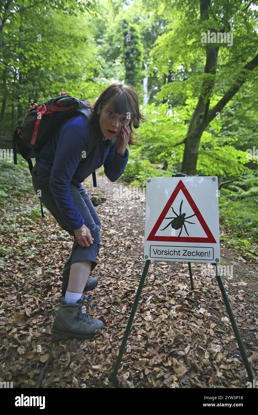 A hiker fears a tick bite, Warning sign, Caution ticks, Insects Hesse ...