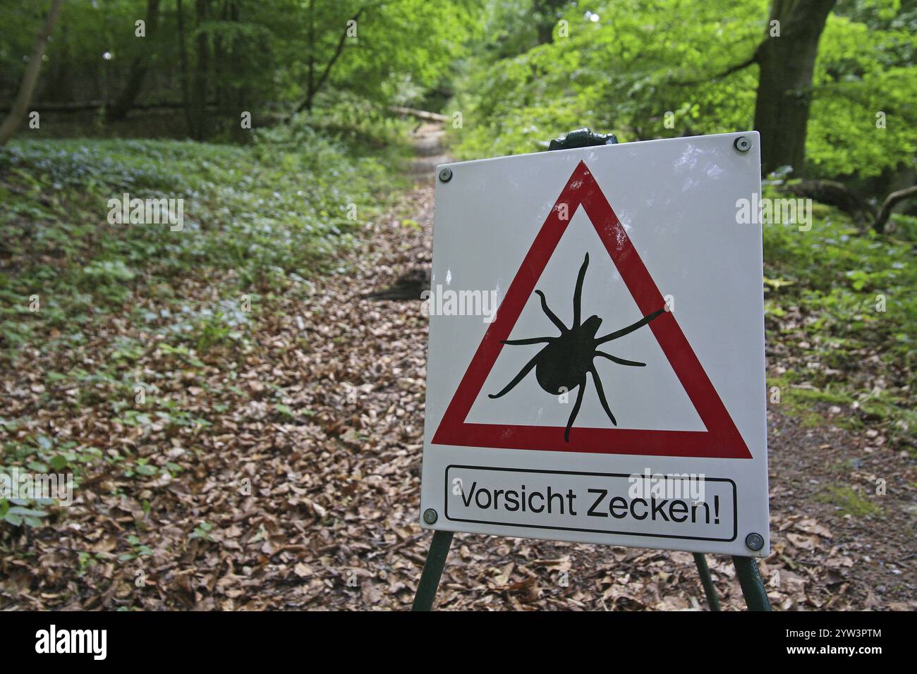 A hiker fears a tick bite, Warning sign, Caution ticks, Insects Hesse ...