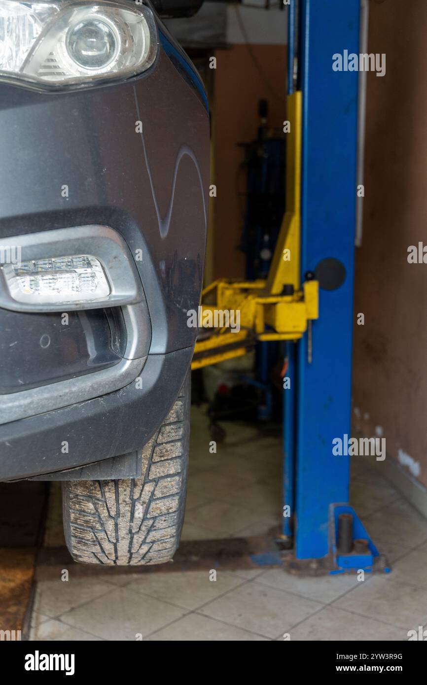 Gray car on auto lift in garage for repair and maintenance service. Car ...