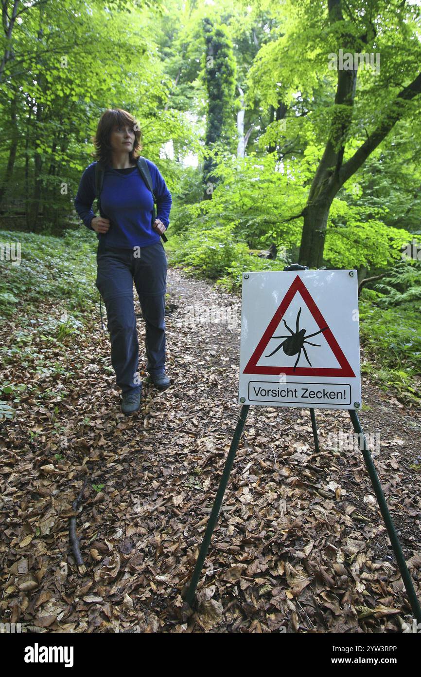 A hiker fears a tick bite, Warning sign, Caution ticks, Insects Hesse ...