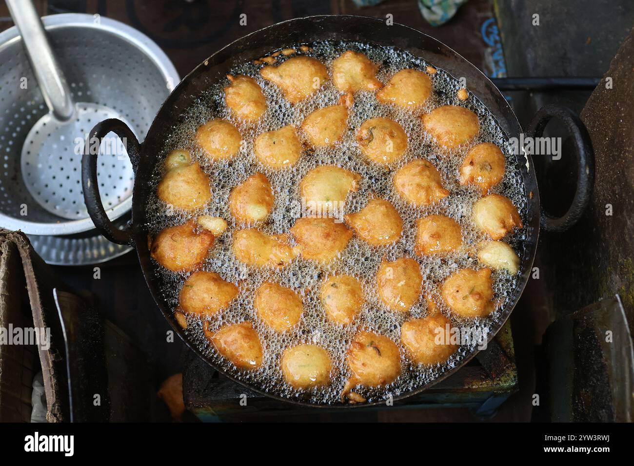 Vada frying in a pan at a street food stall in Tirupathi, Andhra ...