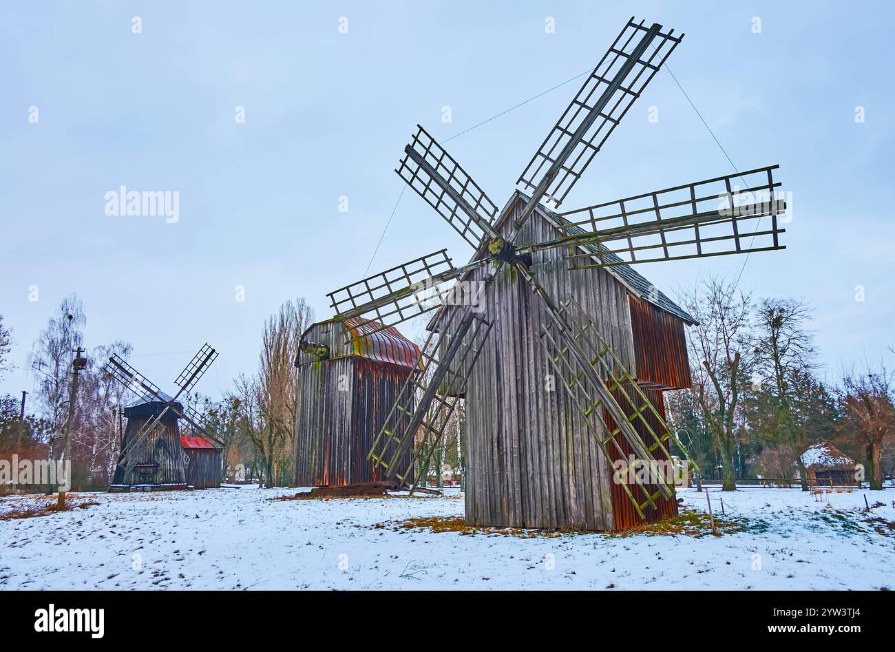 The scenic old wooden windmills with preserved big sails in winter ...