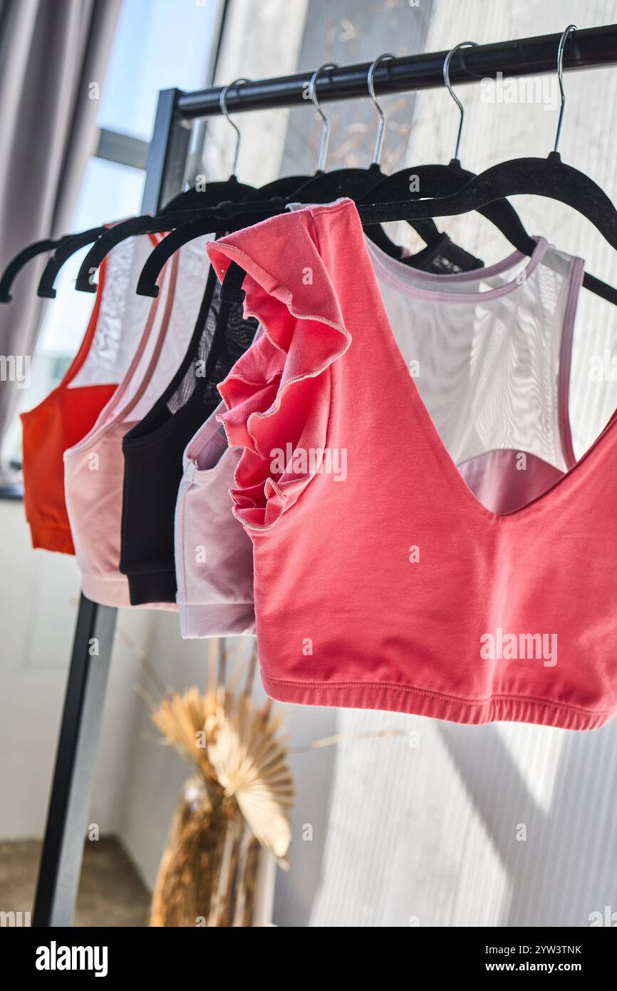 Collection of Stylish Sports Bras on Rack Stock Photo - Alamy