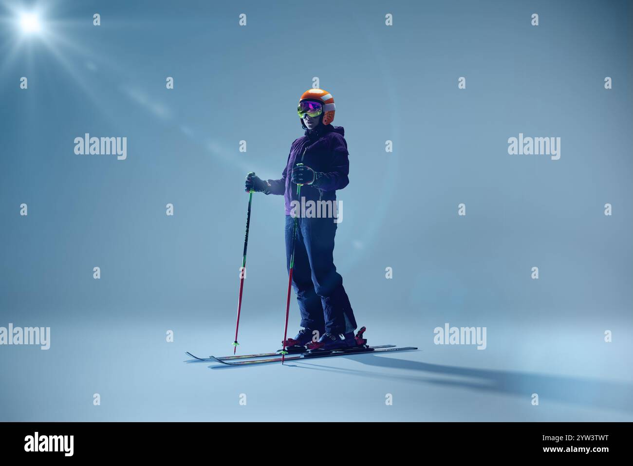 Athletic woman, skier stands confidently holding poles in hand against ...